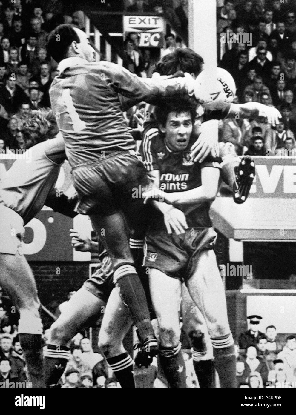Liverpool's Gary Ablett is sandwiched as Liverpool goalkeeper Bruce ...