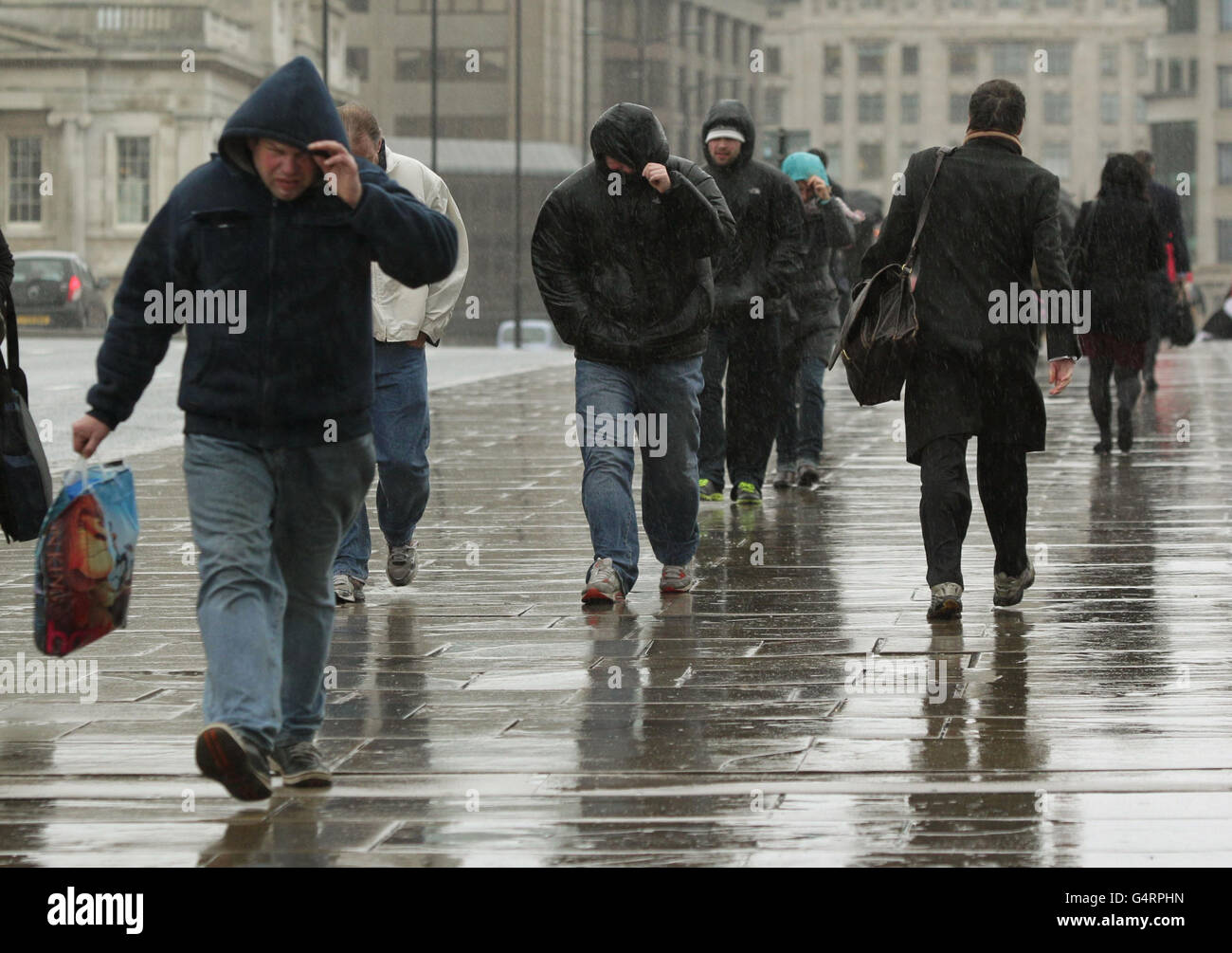 People walking in the wind and rain on London Bridge as fierce storms ...