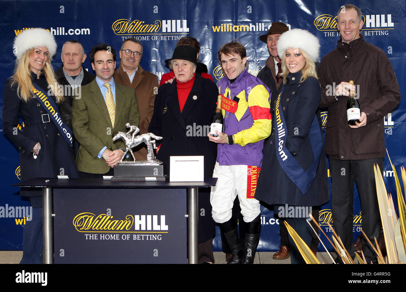 Jockey Tom Scudamore and Trainer David Pipe (right) are presented with ...