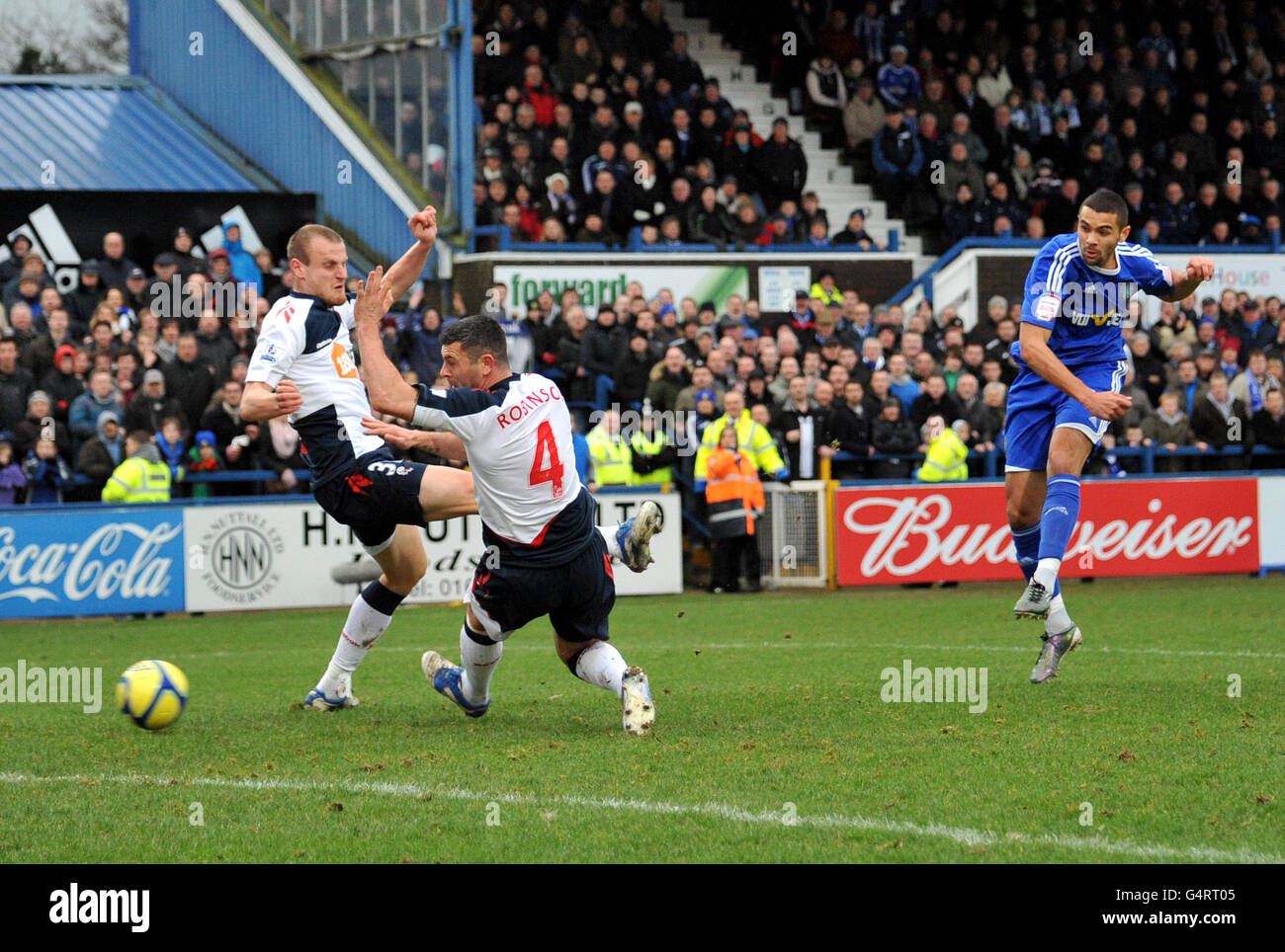 Macclesfield Town's Colin Daniel gets the ball between Bolton Wanderers ...