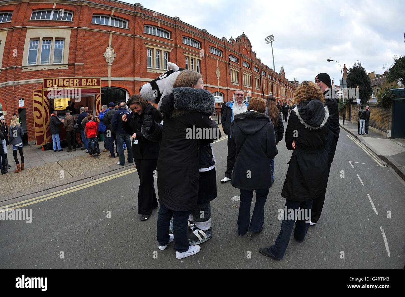 Fulham mascot Billy the badger hugs fans outside of Craven Cottage ...