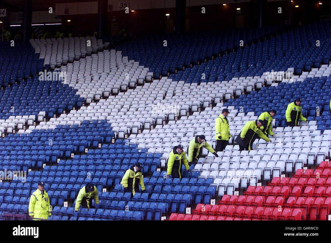 Football stadium seating security guards checking yellow coats caps hi ...