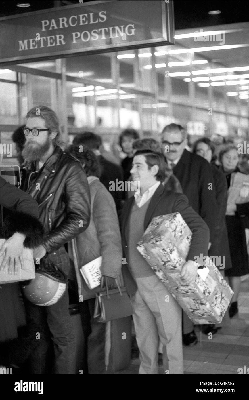 People queue in the Trafalgar Square post office for longer than usual ...