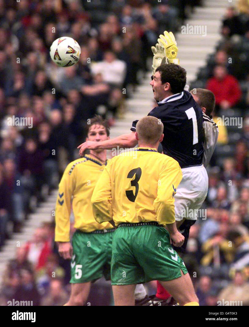 Scotland`s Christian Dailly jumps up against Lithuania`s Marius ...