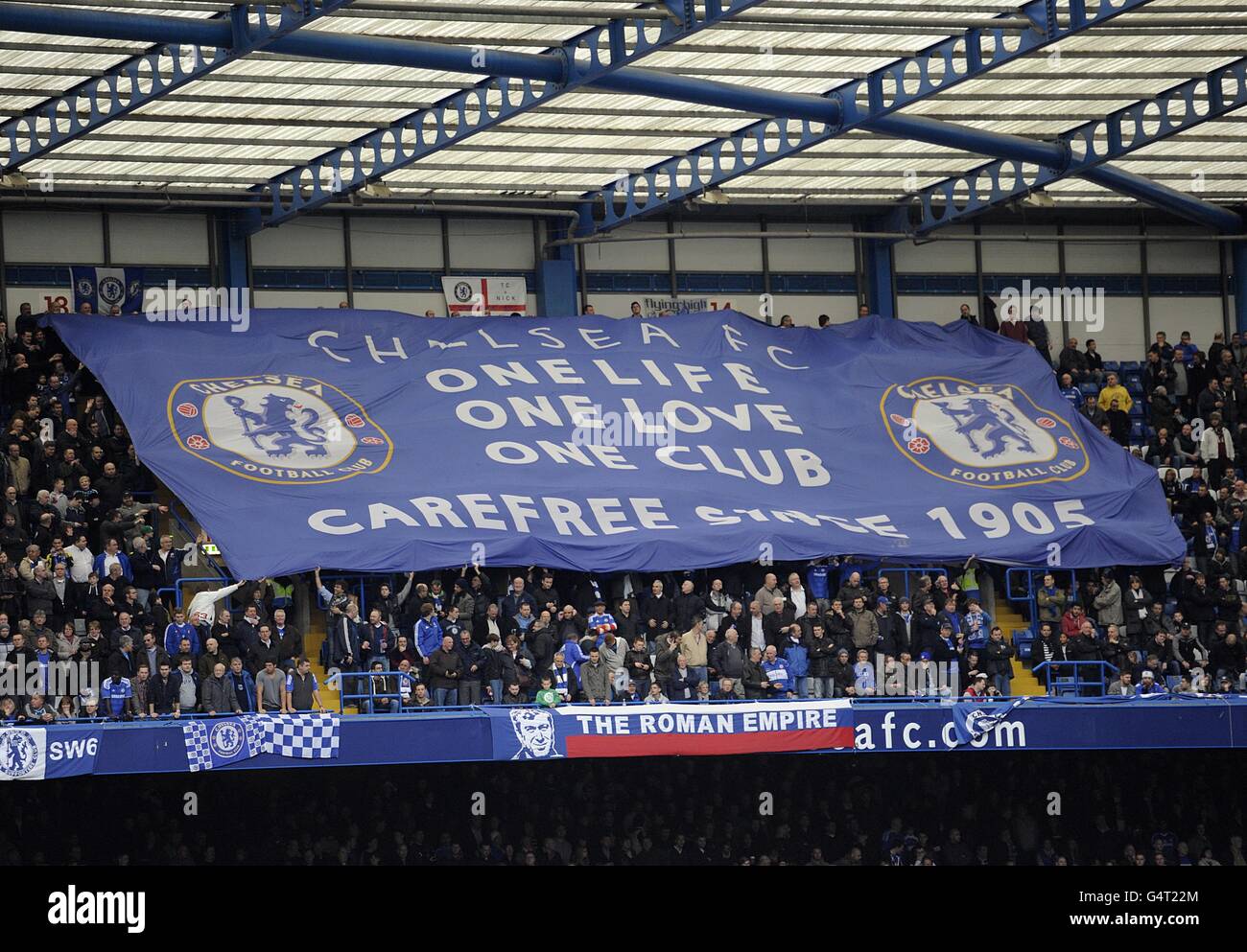 Chelsea fans with a giant flag in the stands hi-res stock photography ...