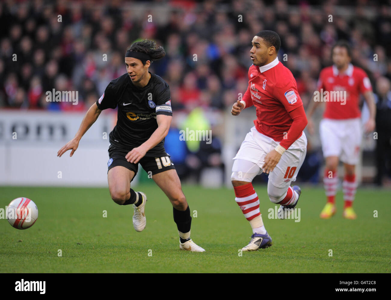 Nottingham Forest's Lewis McGugan (right) is challenged by Peterborough ...