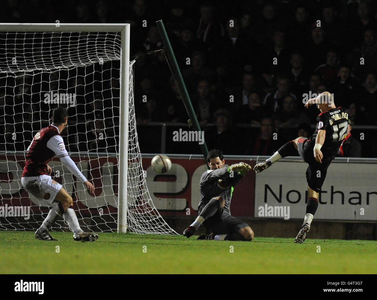 Swindon Town's Alan McCormack scores past Northampton Town's goalkeeper ...