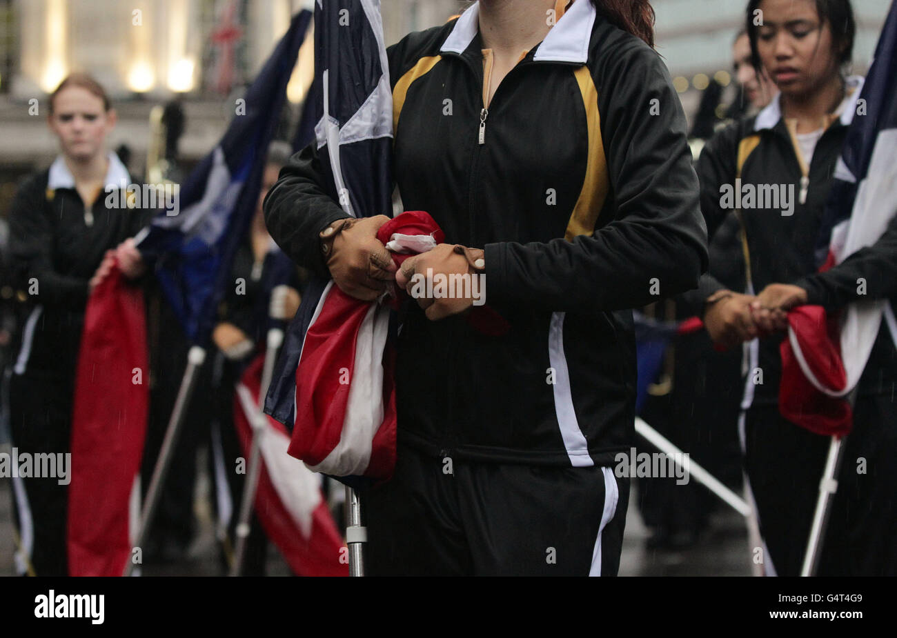 Participants wring out their wet flags during the New Year's Day parade ...
