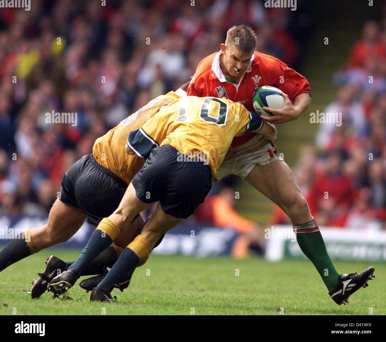 Wales's Dafydd James is tackled by Australia's Stephen Larkham (Number ...