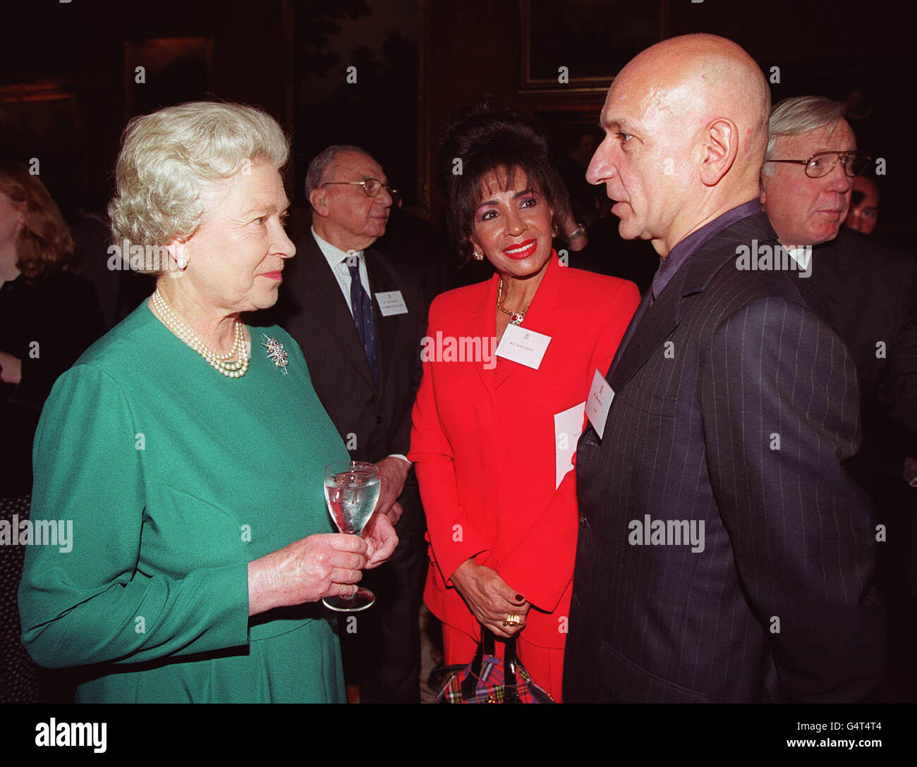 The Queen speaks with actor Ben Kingsley, while singer Shirley Bassey ...