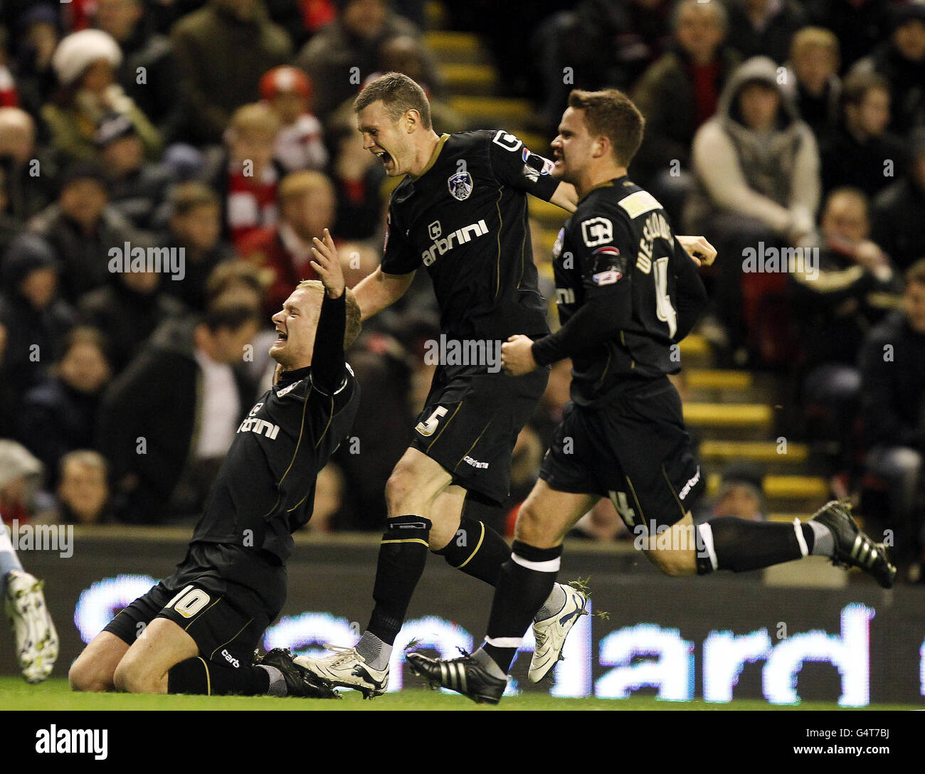 Oldham's Robbie Simpson (left) celebrates scoring his sides first goal ...