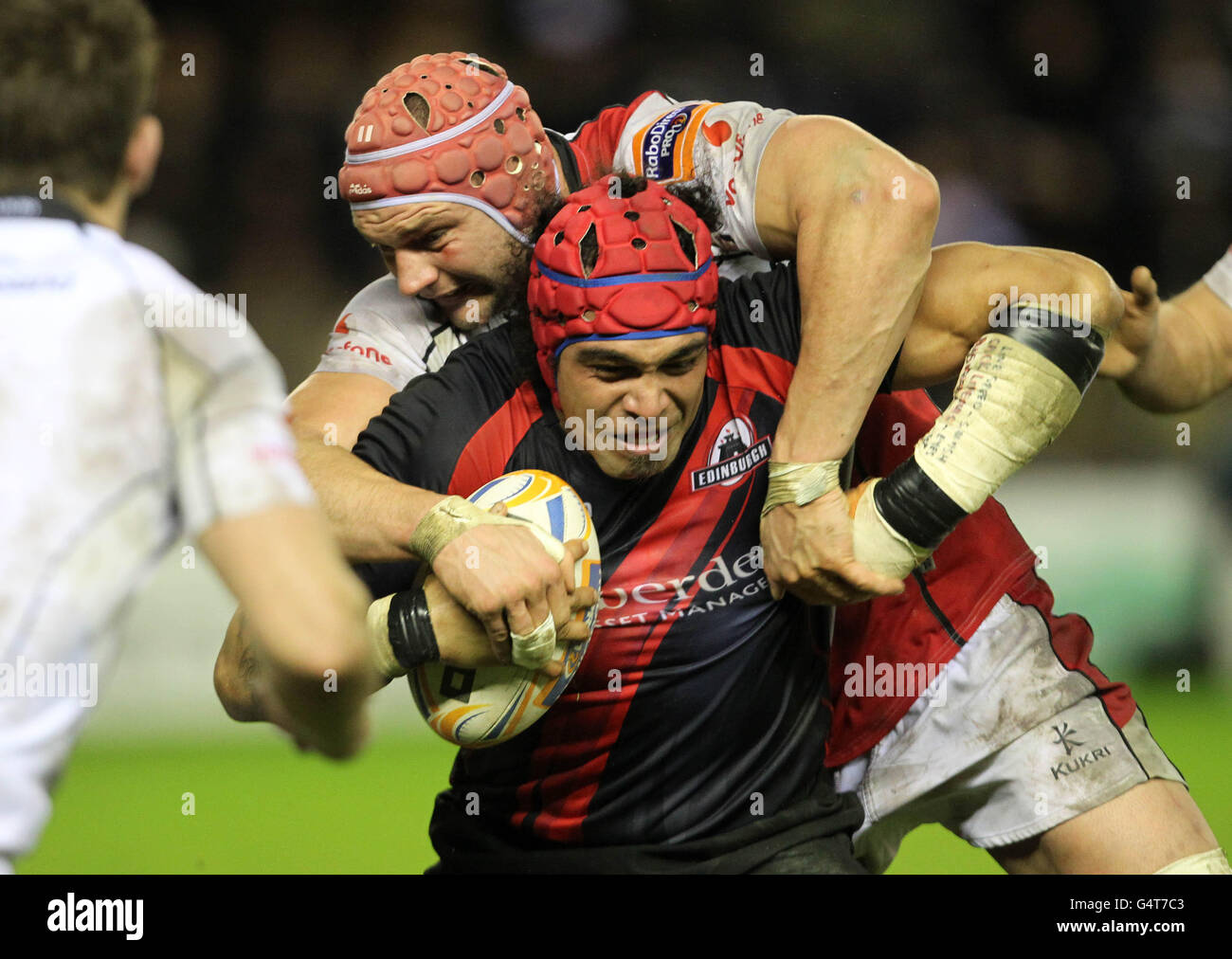 Ulster's Dan Tuohy tackles Edinburgh's Netani Talei (front) during the ...