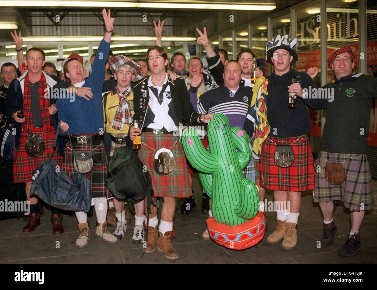 Football kilt tartan sporran inflatable cactus victory sign smiling hi ...