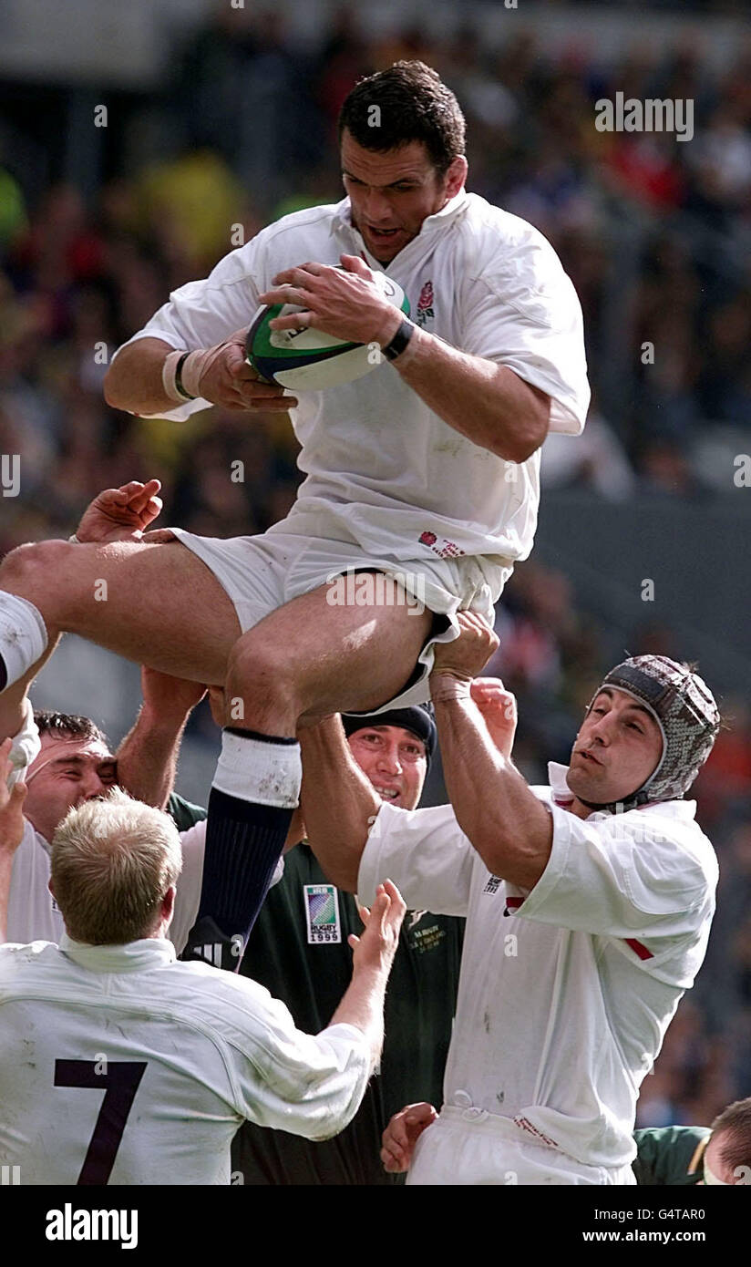 England captain Martin Johnson (holding ball) gets a lift to win a line ...