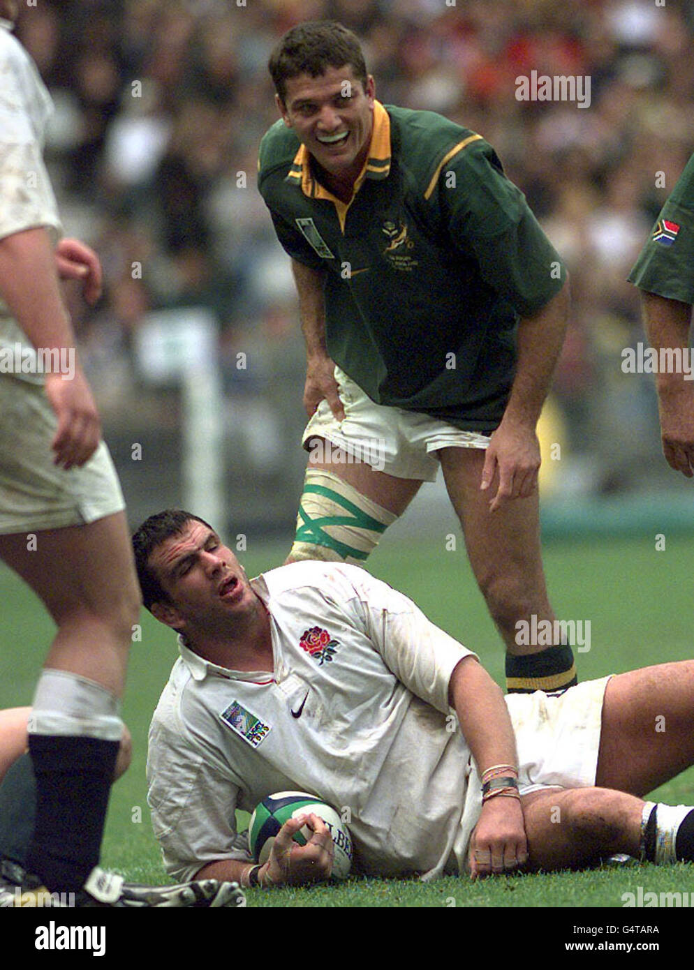 England's captain Martin Johnson (lying down) rests as South Africa's ...