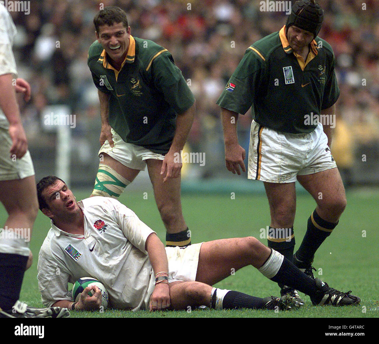 England's captain Martin Johnson (lying down) rests as South Africa's ...