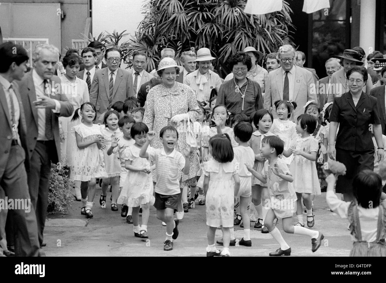 Queen Elizabeth II surrounded by enthusiastic Chinese children with ...