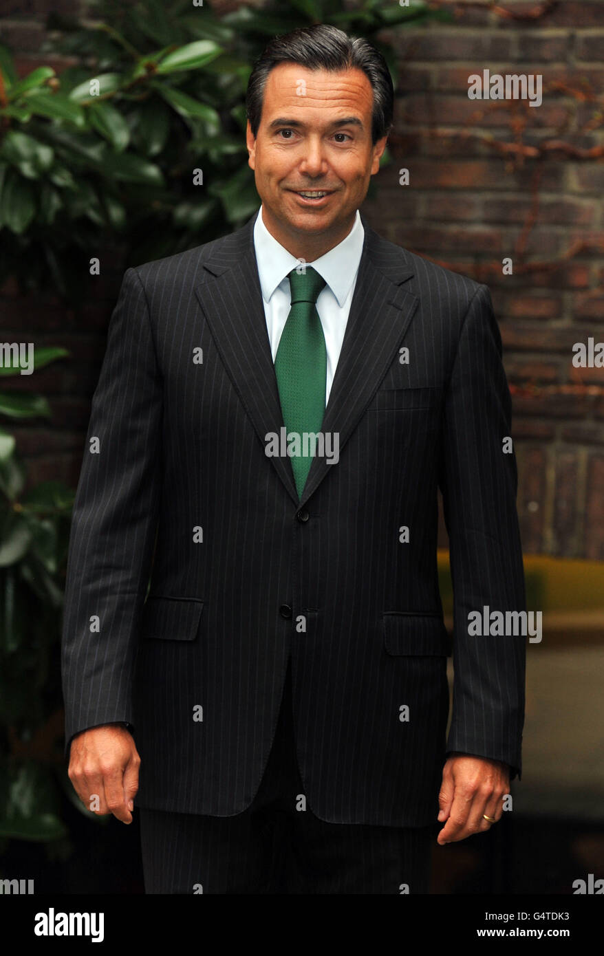 Exhausted bank boss returns to work Stock Photo - Alamy