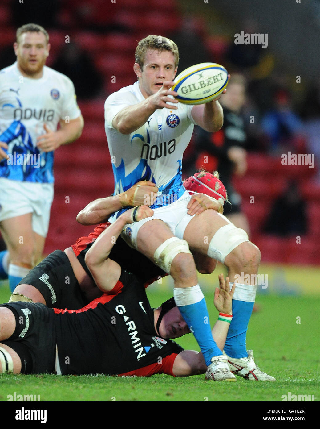 Saracens' Andy Saull (on ground) and Mouritz Botha (hidden) tackle Bath ...