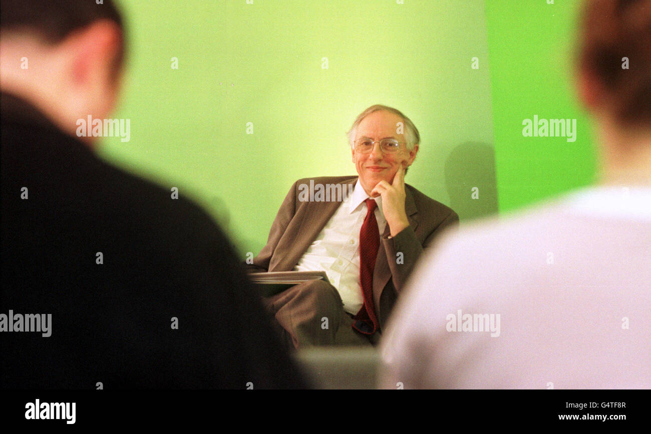 Scottish First Minister Donald Dewar smiles as he sits down after ...
