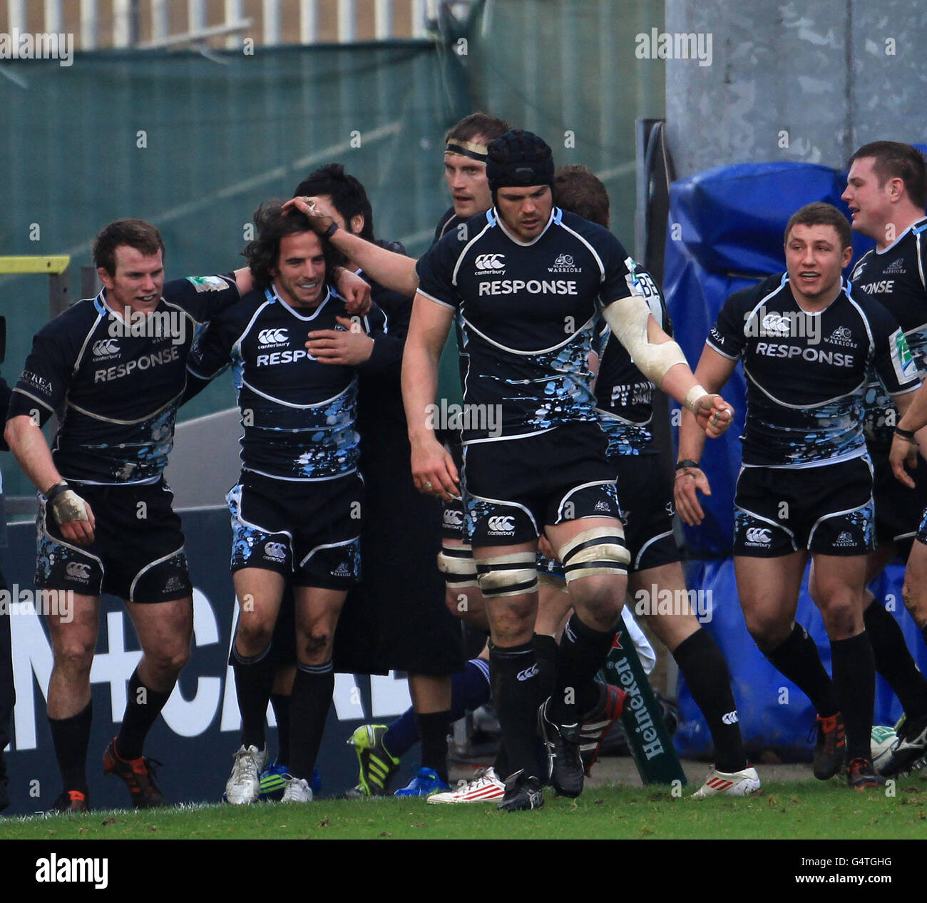 Glasgow's Colin Gregor (second left) celebrates a tryduring the ...