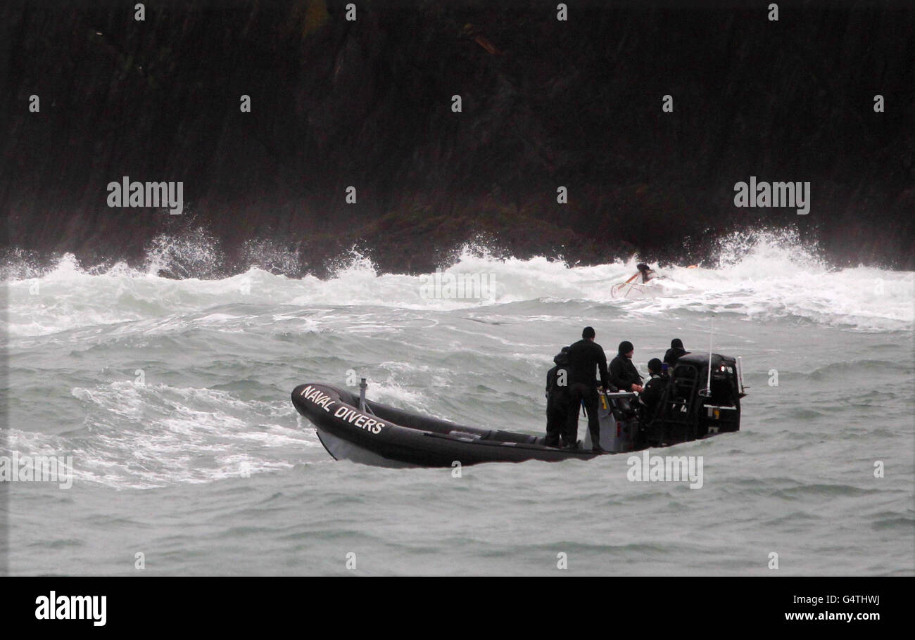 Naval Divers look at the wheelhouse of the sunken ship off Adam Island ...