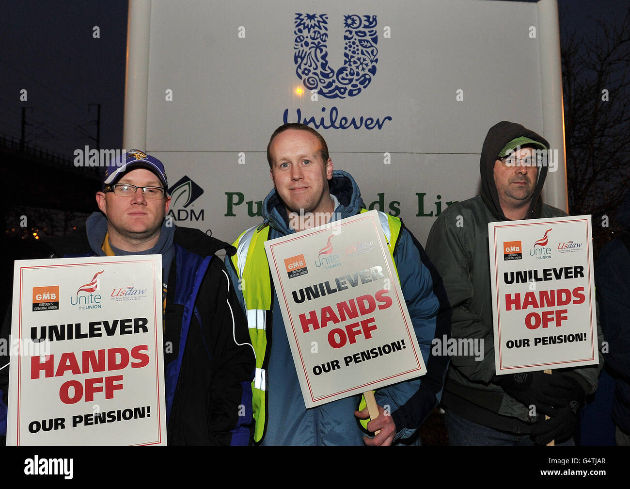 A group of workers form a picket line outside the main entrance to the ...