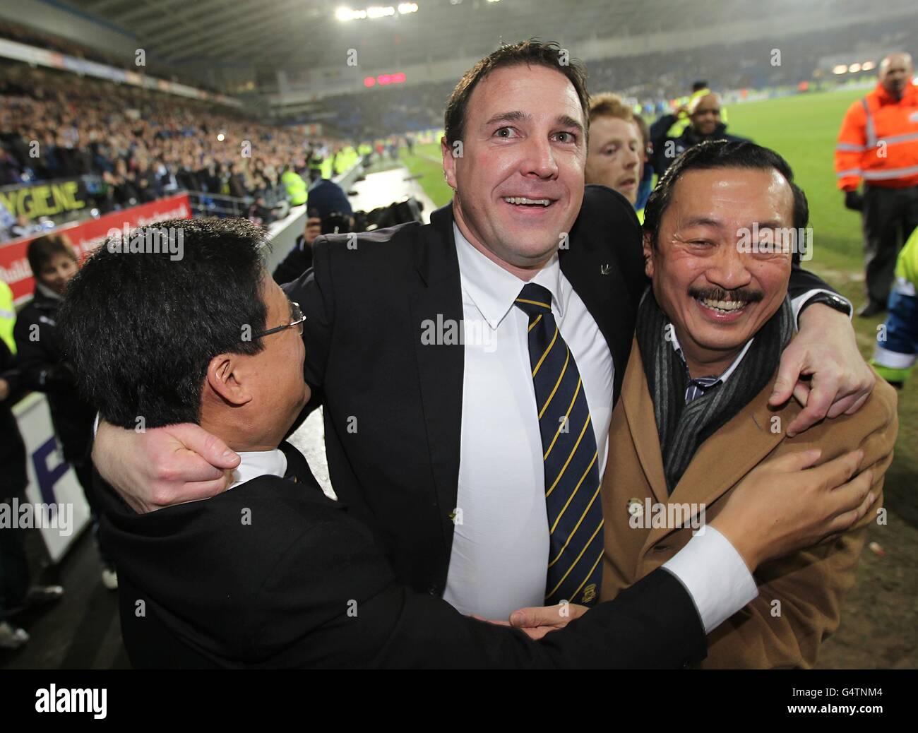 Malky Mackay (centre) celebrates with club owner Tan Sri Vincent Tan ...
