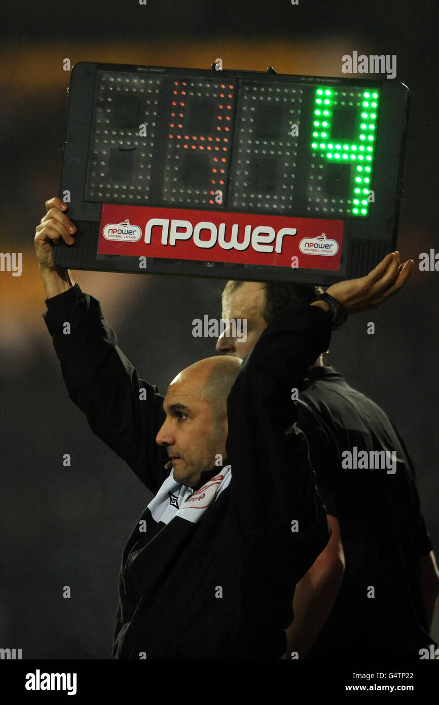 The fourth official holds up an electronic sign indicating 4 minutes of ...