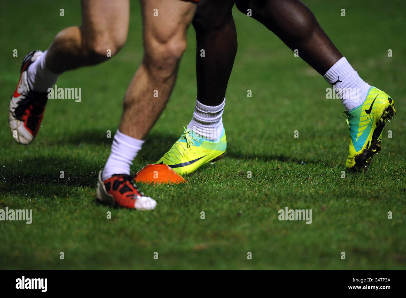 Detail of two footballers legs boots as they warm up hi-res stock ...