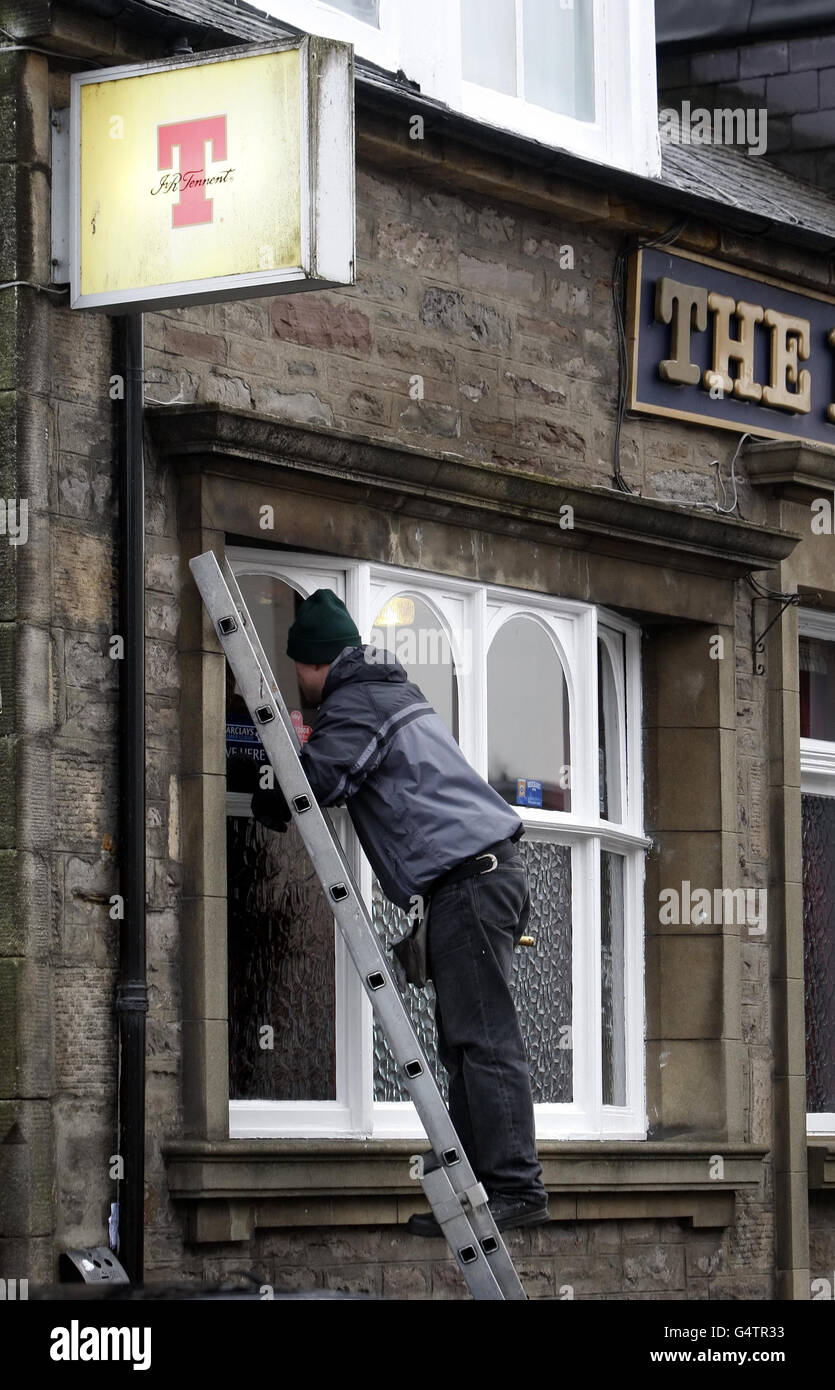 A window cleaner is pictured watching Andy Murray in action during the ...
