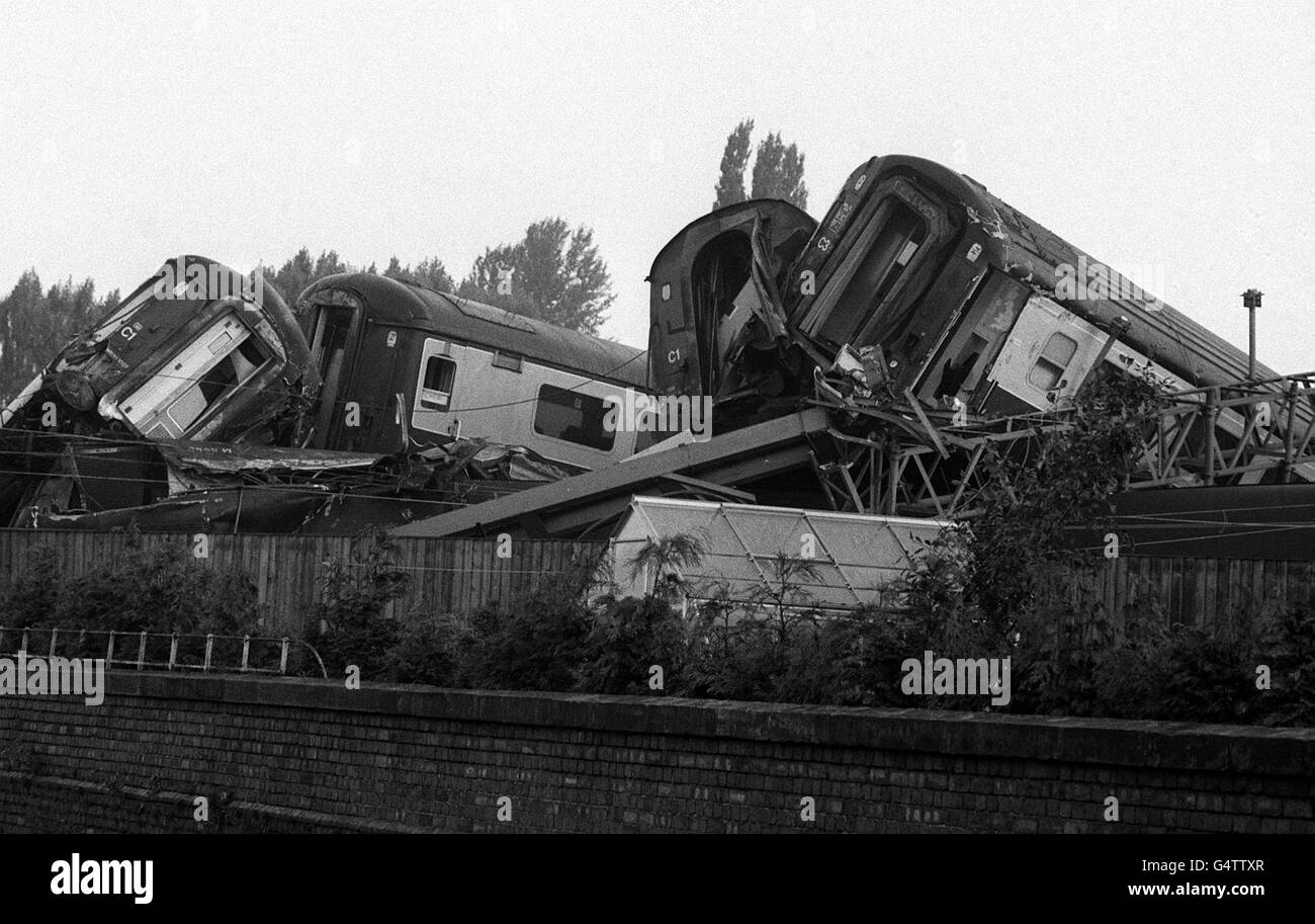 Train carriages and debris lie strewn across the tracks following an ...