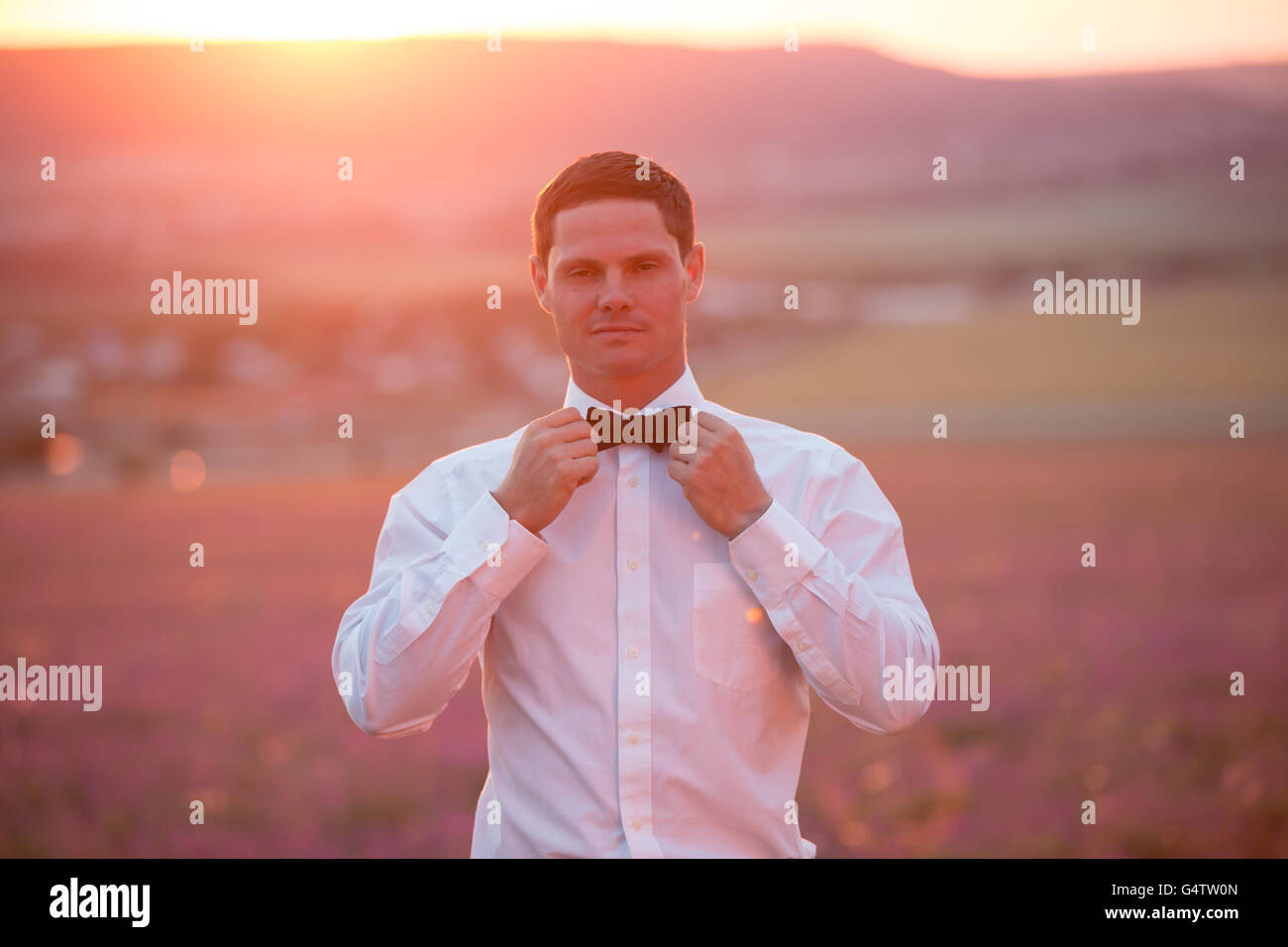 Elegant young guy posing on lavender field at sunset time Stock Photo ...