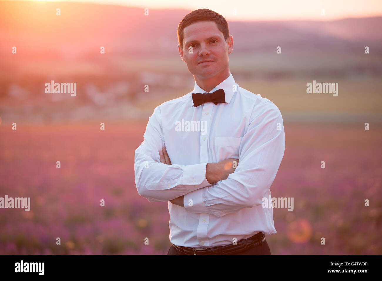 Elegant young guy posing on lavender field at sunset time Stock Photo ...