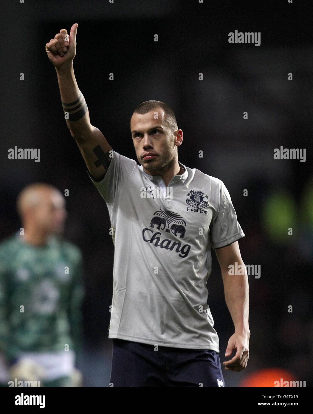 Everton's Johnny Heitinga salutes the travelling fans after the final ...