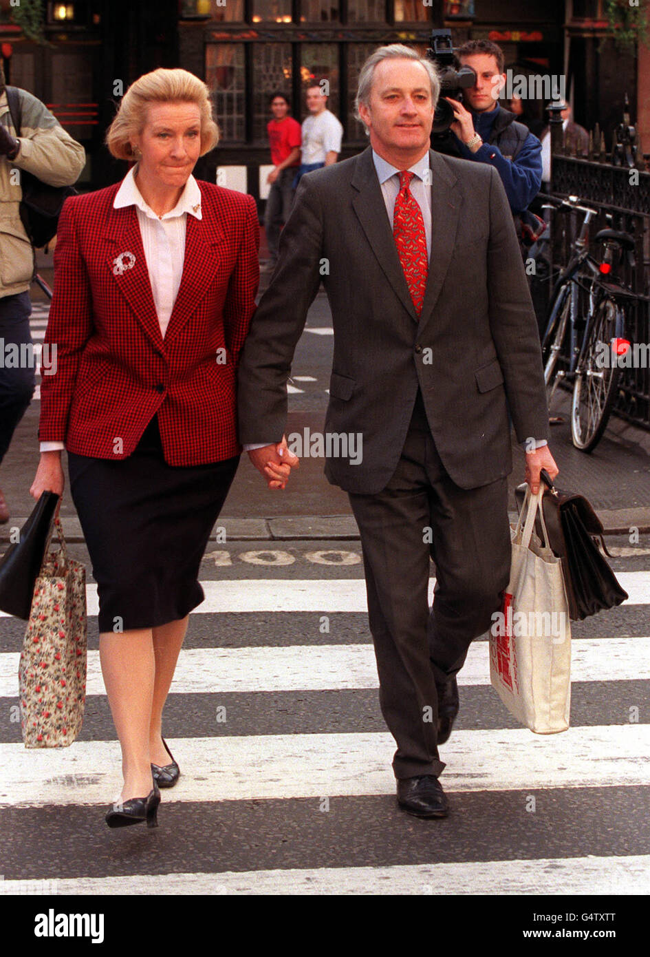 Former Tory minister Neil Hamilton and his wife Christine walk hand in ...