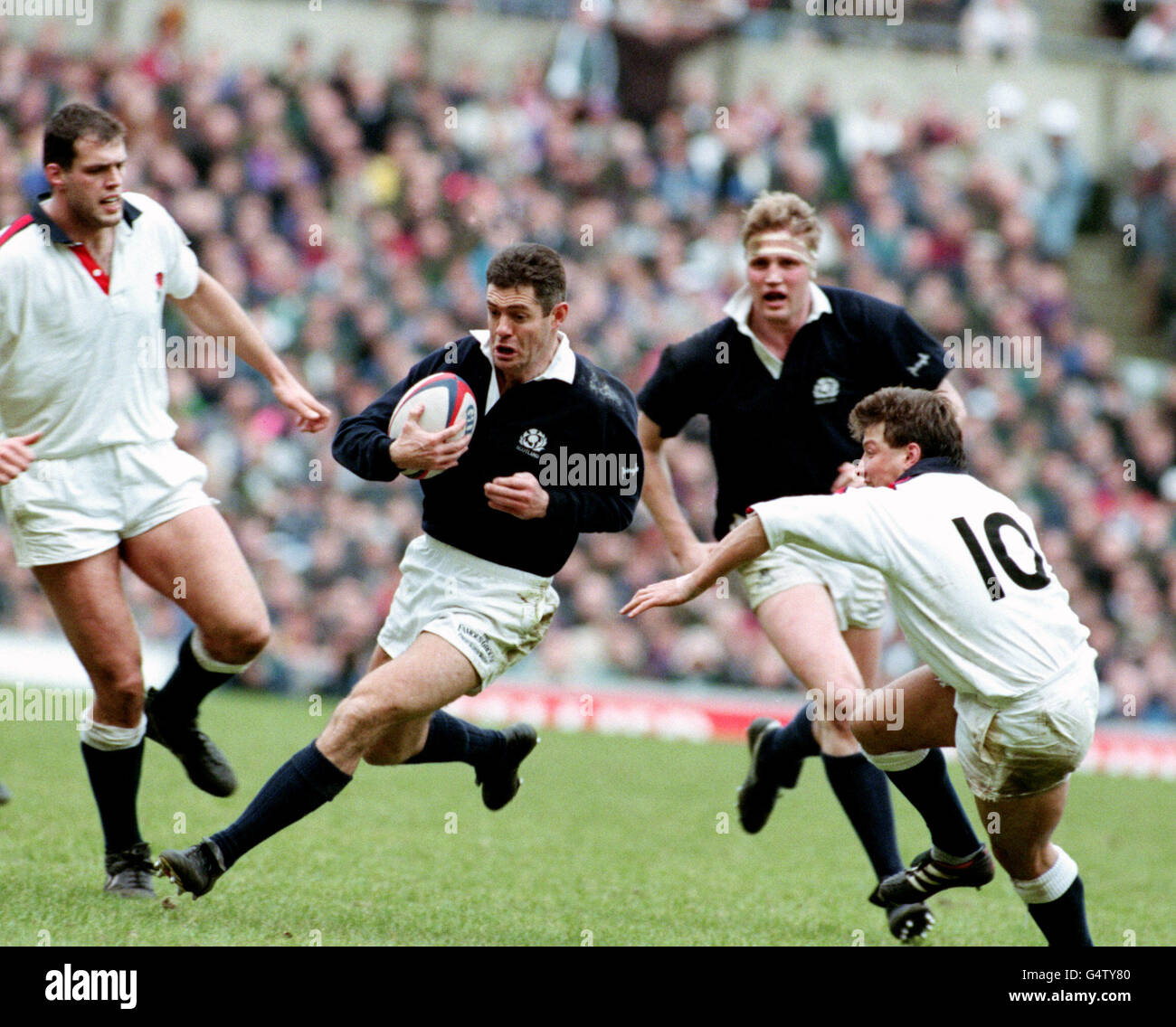 Scotalnd's captain Gavin Hastings passes Rob Andrew's tackle during the ...
