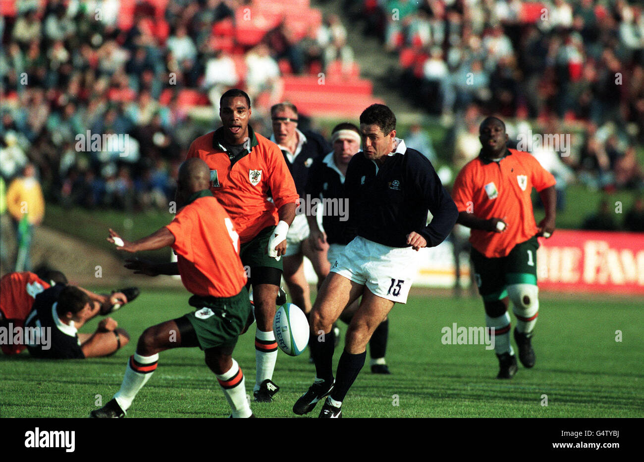 Scotland's Captain Gavin Hastings (C) chips the ball through the Ivory ...