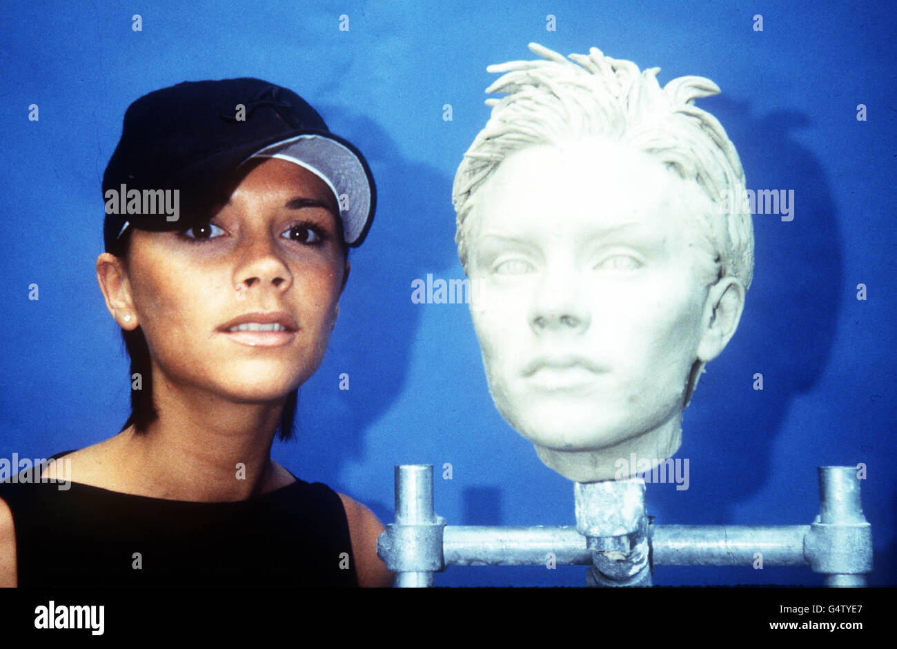 Spice Girl Victoria Adams posing next to a clay head during her second ...