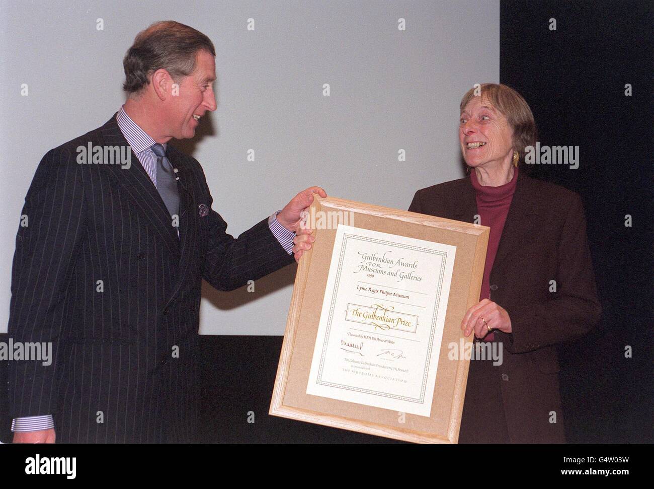 The Prince of Wales presents an award for exceptional achievement to ...