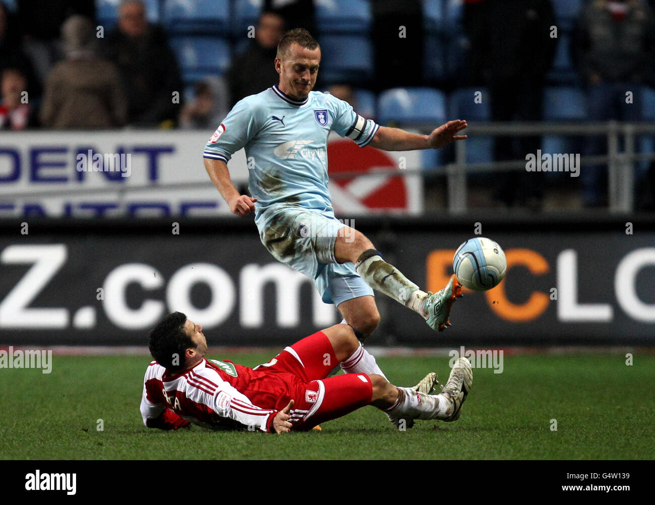 Coventry City's Sammy Clingan is tackled by Middlesbrough's Julio Arca ...