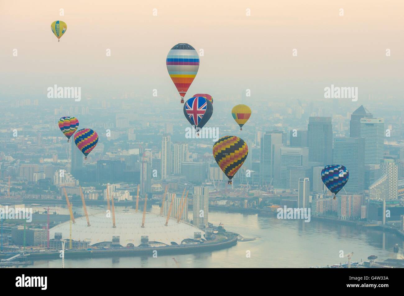 Hot air balloons fly over the O2 Arena and Canary Wharf in London ...