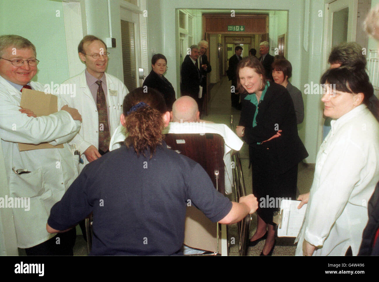 Scottish Health Minister Susan Deacon speaks to a patient as he is ...