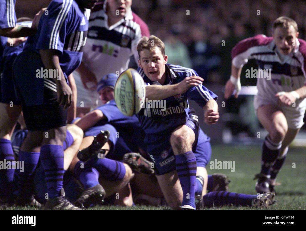 Bath scrum half Jon Preston (centre) clears from the base of the ruck ...