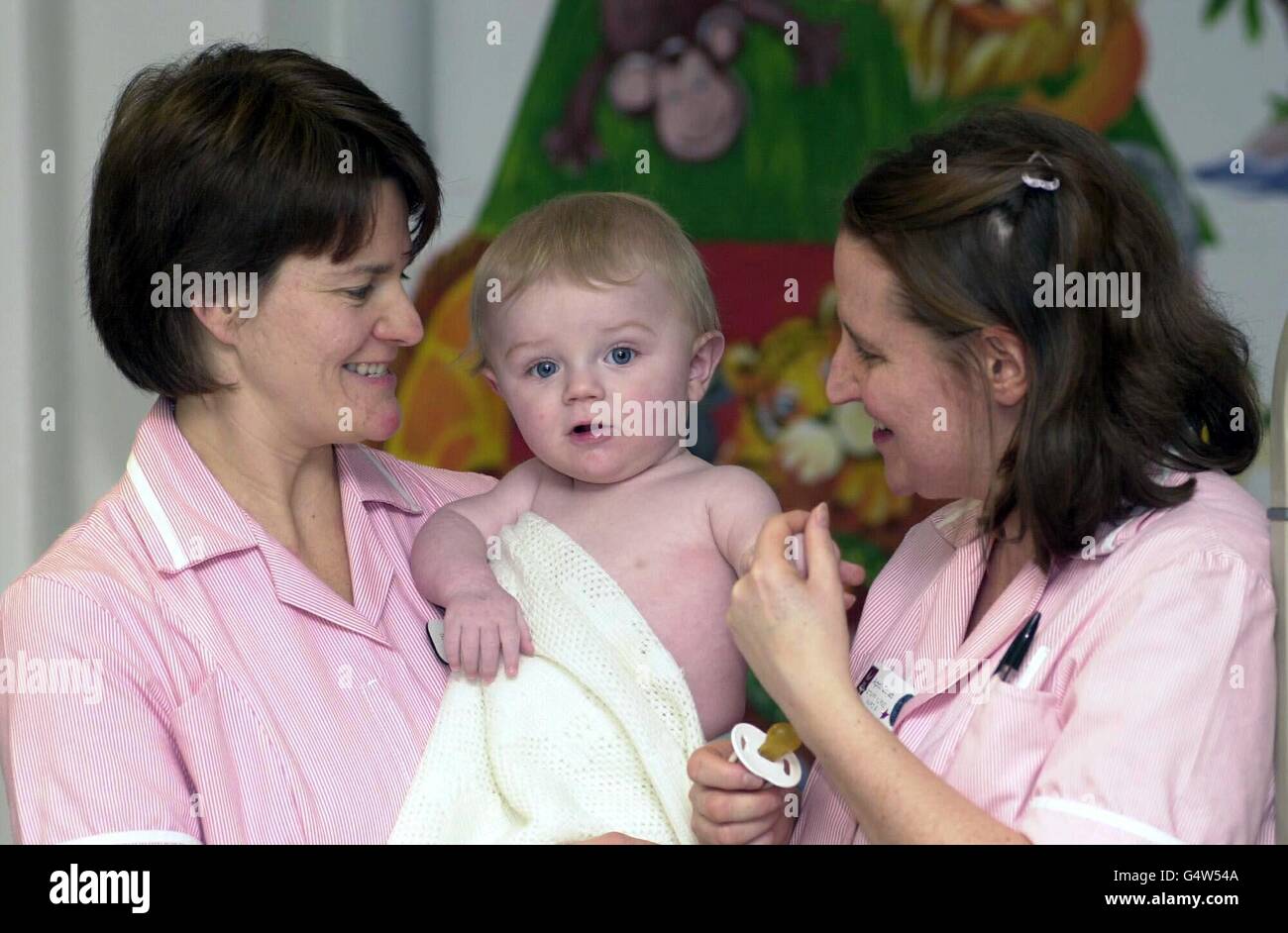 Staff nurses Hilary Taylor (L) and April Govan talk to seven month old ...