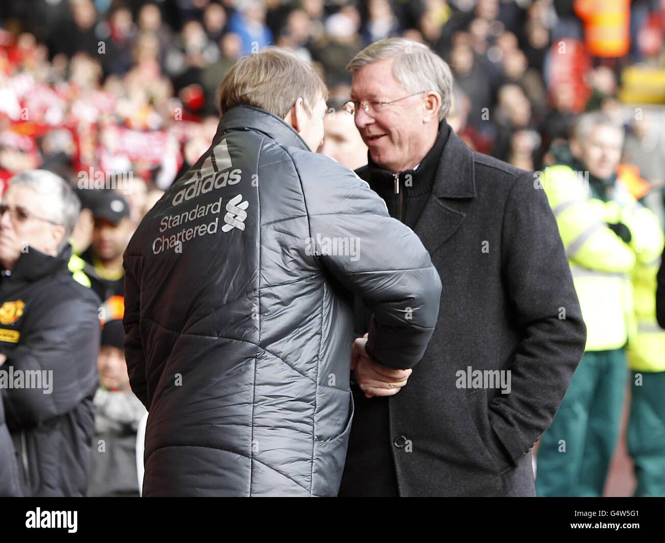 Liverpool manager Kenny Dalglish (left) shakes hands with Manchester ...