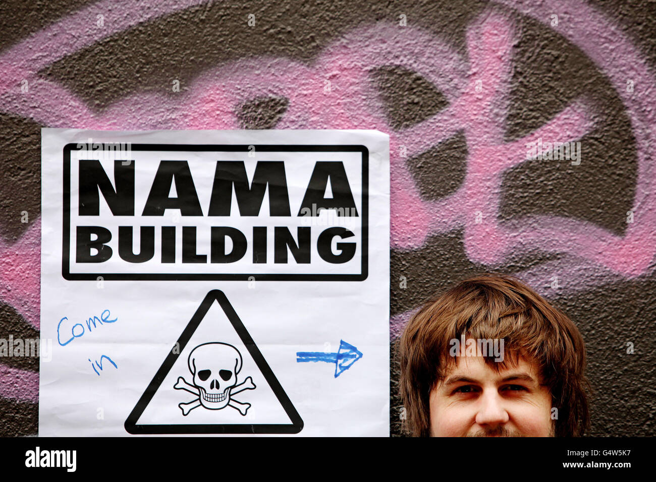 A member of Unlock NAMA (name not known) outside an occupied building ...