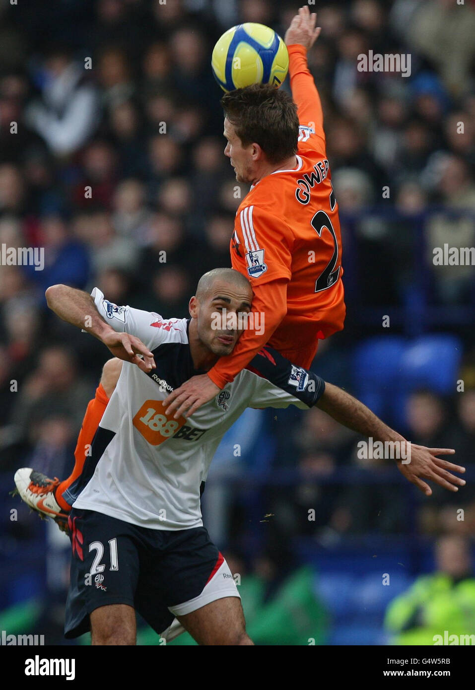 Swansea City's Mark Gower jumps onto Bolton Wanderers Darren Pratley ...