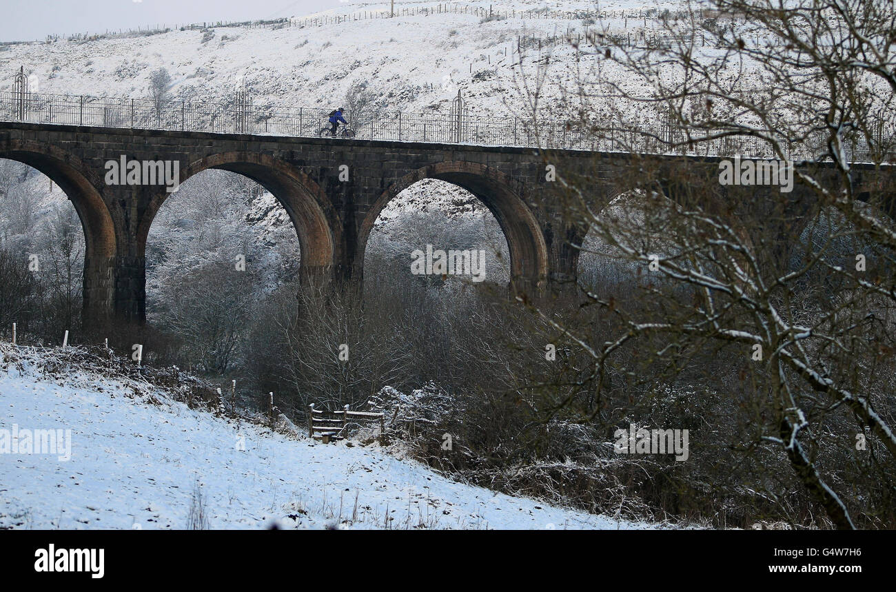 A cyclist makes his way home in the snow in Merthyr Tydfil Stock Photo ...