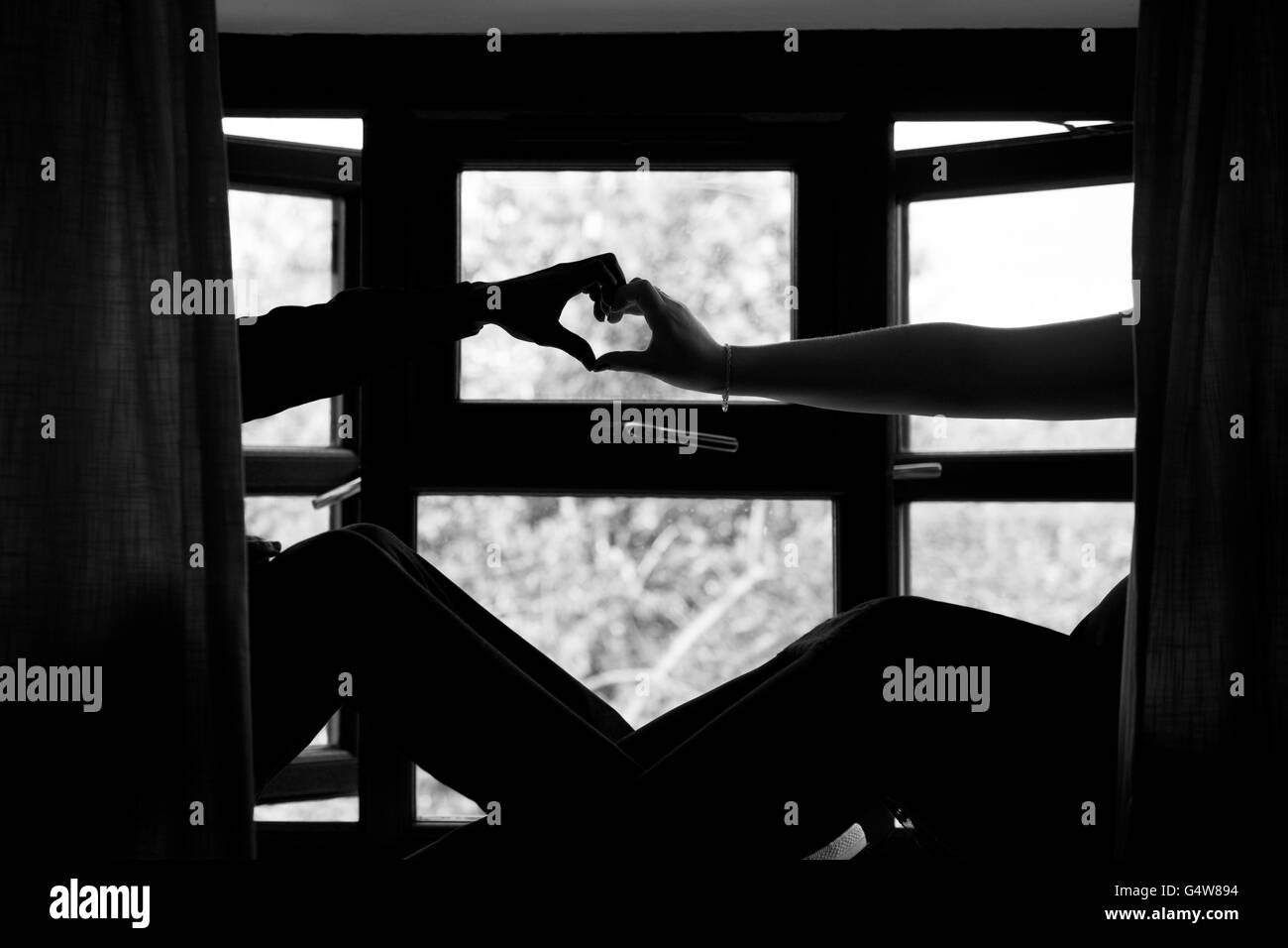 Hands touching silhouette hi-res stock photography and images - Alamy